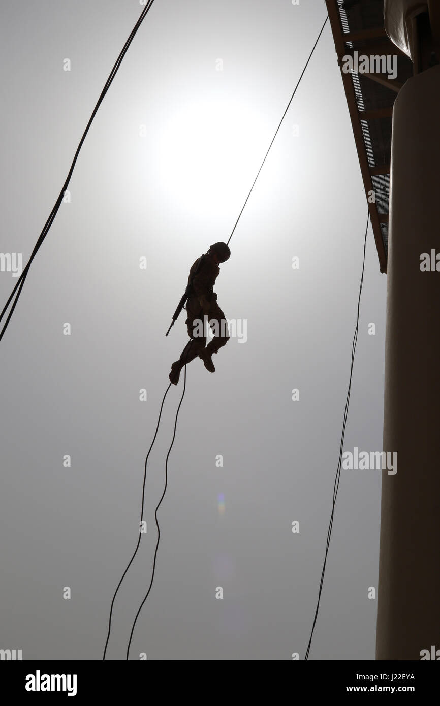 A U.S. Servicemember navigates the rappel tower during day eight of U.S ...