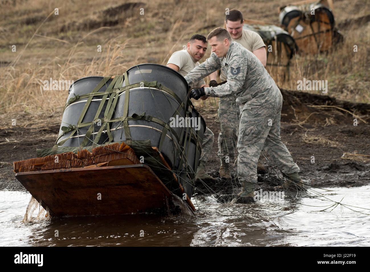 (Right to left) Staff Sgt. William McAtee, Tech Sgt. Daniel Blair, and ...