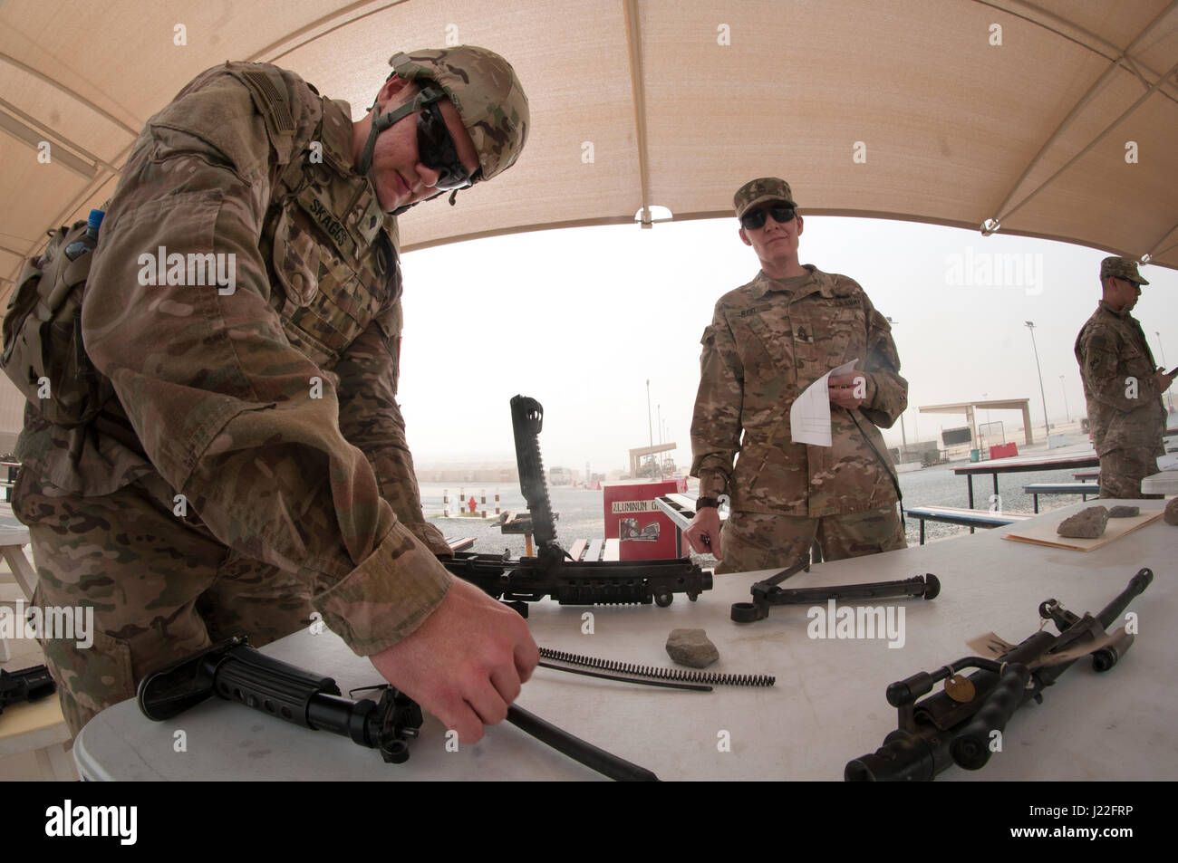 Spc. Jesse Skaggs, a Task Force Sinai Soldier, reassembles a M249 light ...
