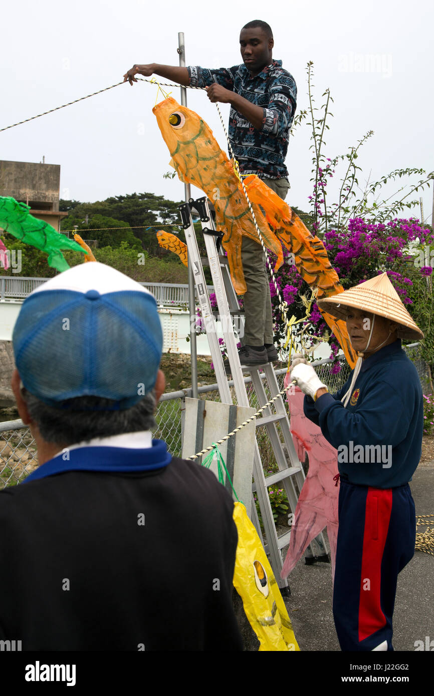 URASOE, OKINAWA, Japan— Lance Cpl. Daron Bush Jr. helps string carp ...
