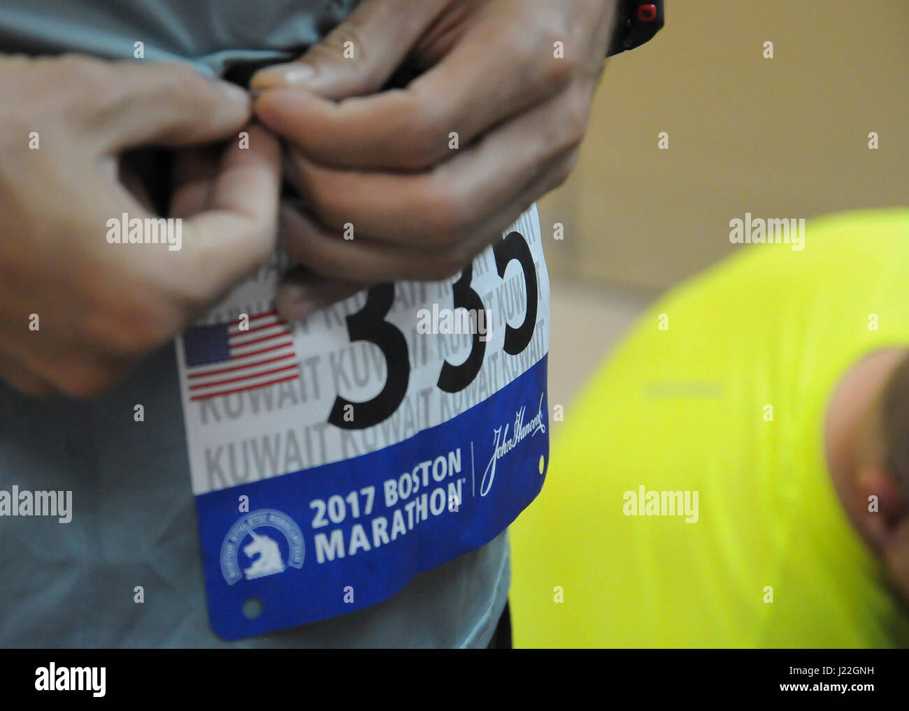A Boston Marathon Shadow Run participant attaches his official bib ...