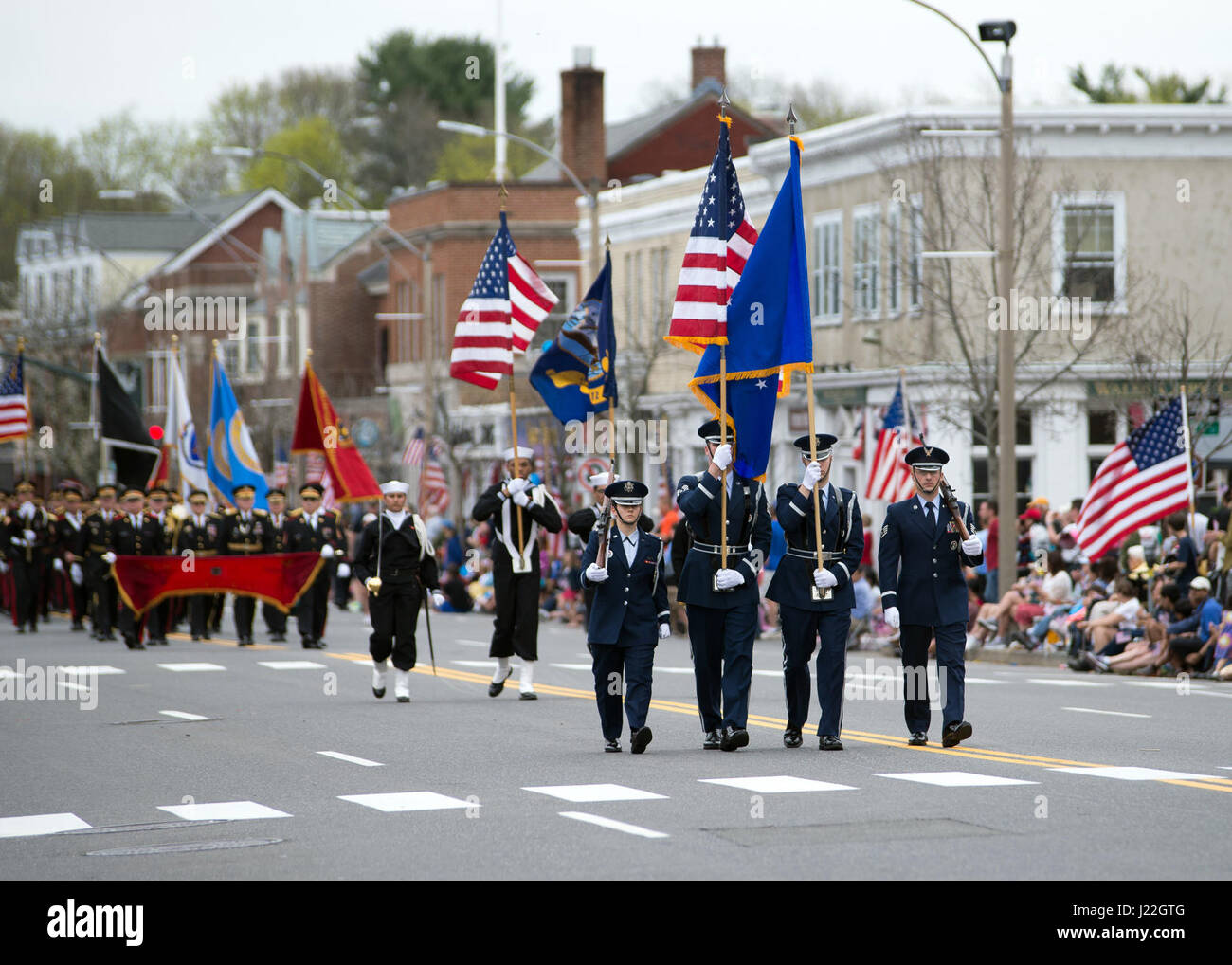 Members of the Patriot Honor Guard participate in a parade during ...