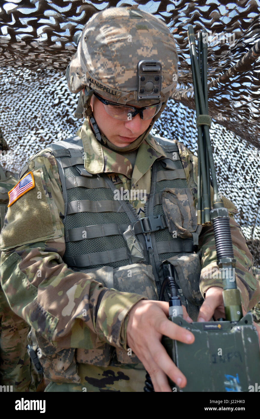 An infantryman practices radio communications during Expert Infantryman ...