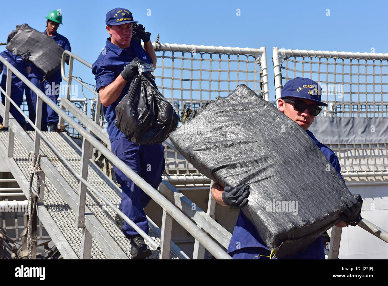 The crew of the Coast Guard Cutter Steadfast offloads contraband during ...
