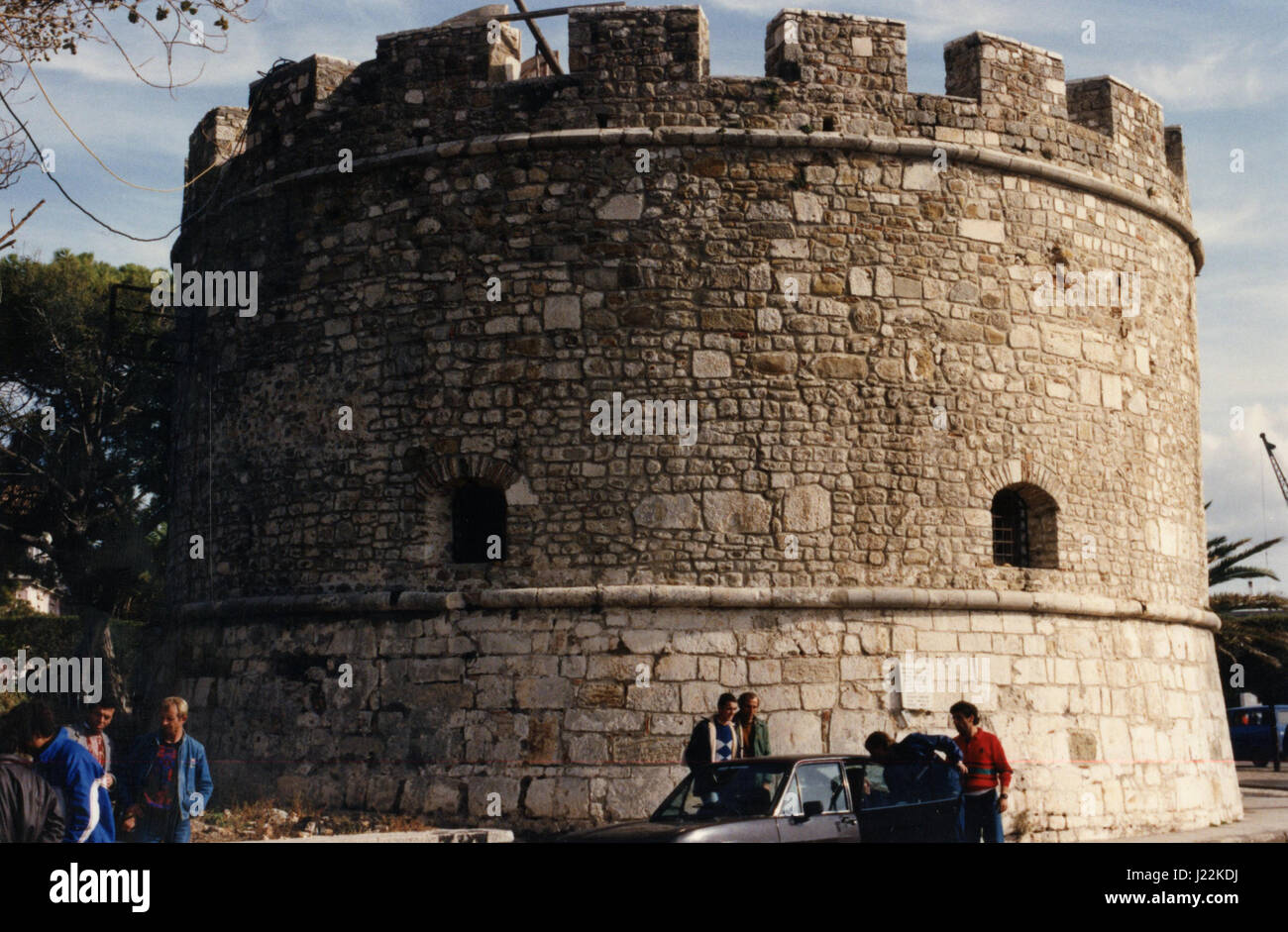 PEOPLE STANDING IN FRONT OF A ANCIENT STYLE CASTLE BUILDING Stock Photo ...