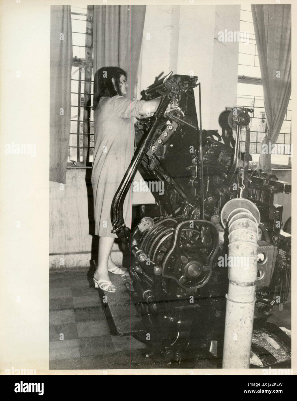 A WOMAN OPERATING A MACHINE Stock Photo - Alamy