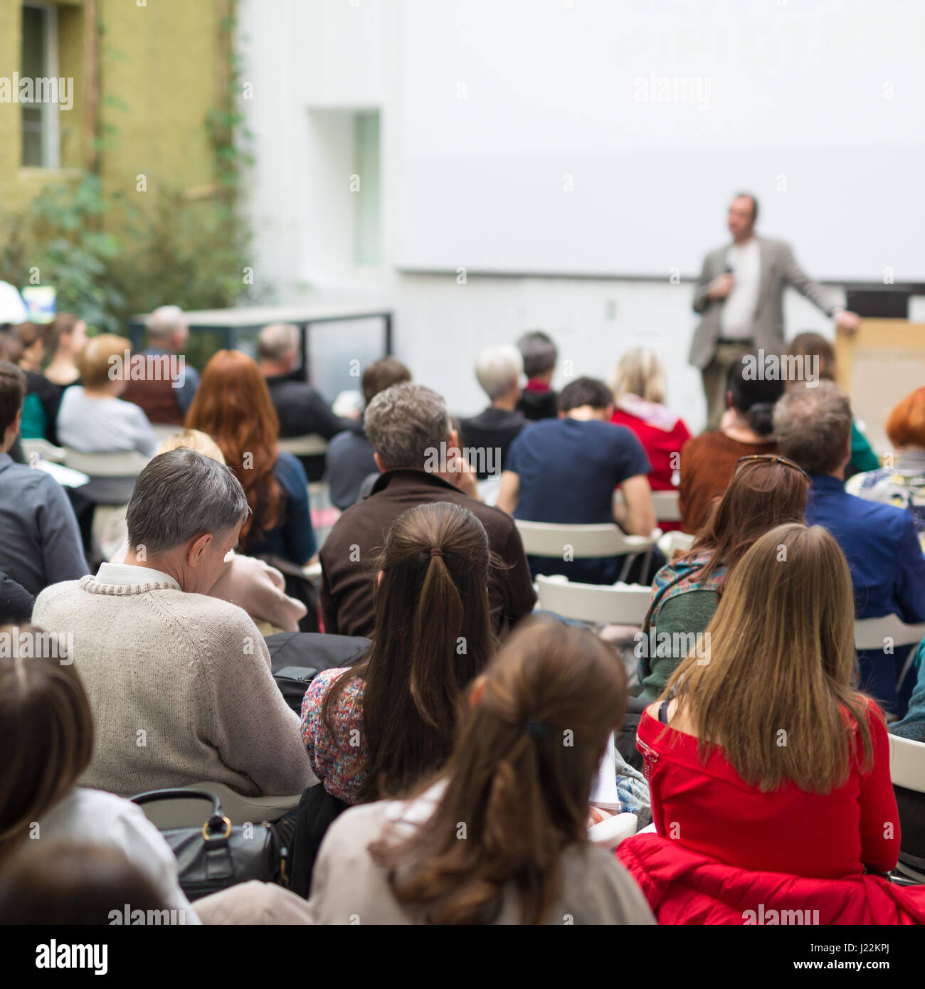 Man giving presentation in lecture hall at university Stock Photo - Alamy