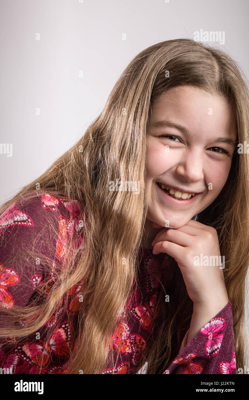 Portrait of an eleven year old girl laughing Stock Photo - Alamy