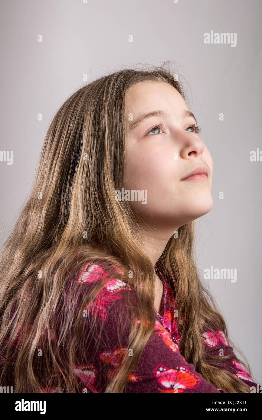 Portrait of an eleven year old girl looking thoughtful Stock Photo - Alamy
