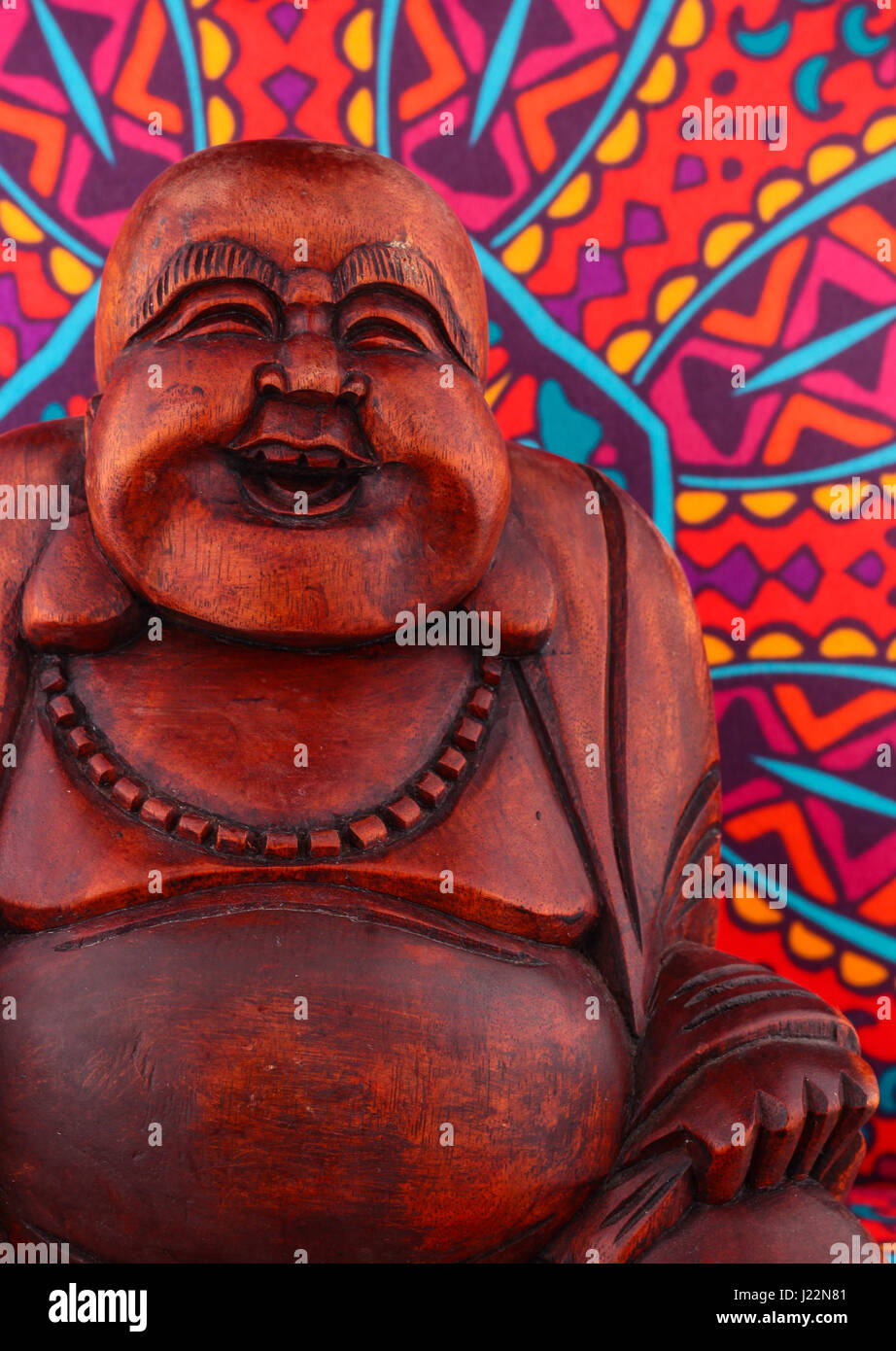 Buddha statue on a colorful background / featuring a wooden statue of ...