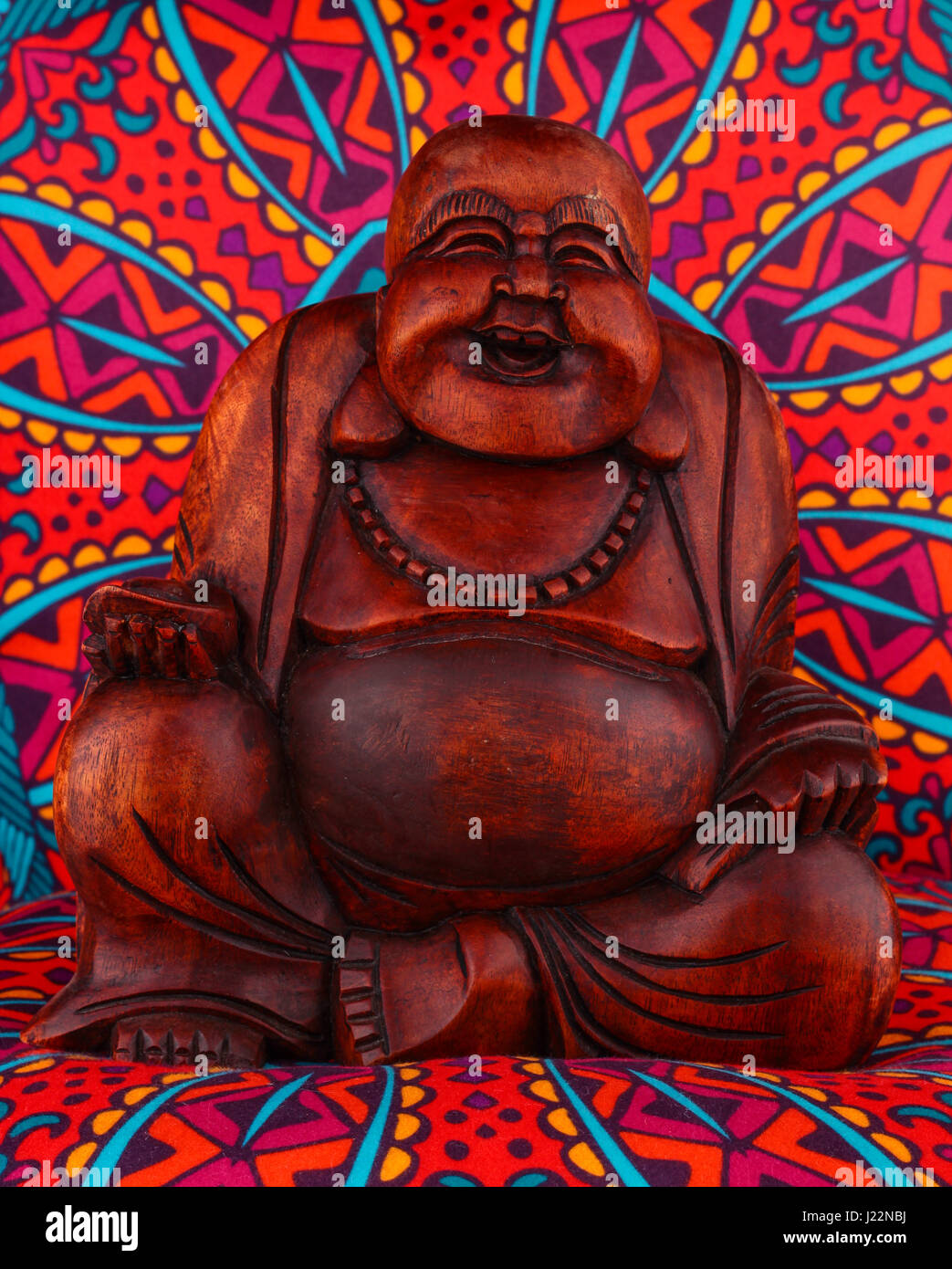 Buddha statue on a colorful background / featuring a wooden statue of ...