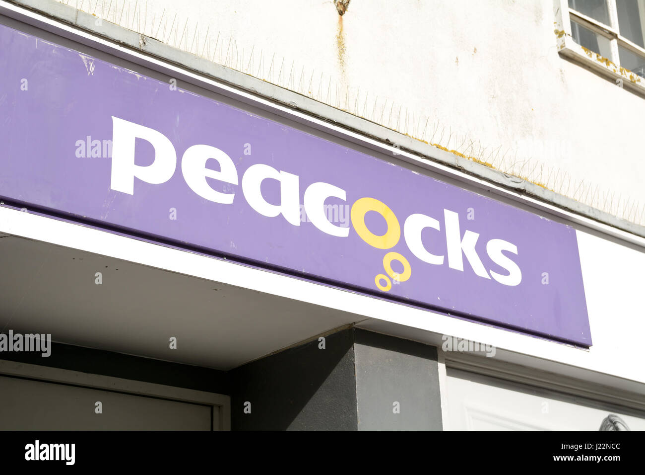 Peacocks shop sign Stock Photo - Alamy