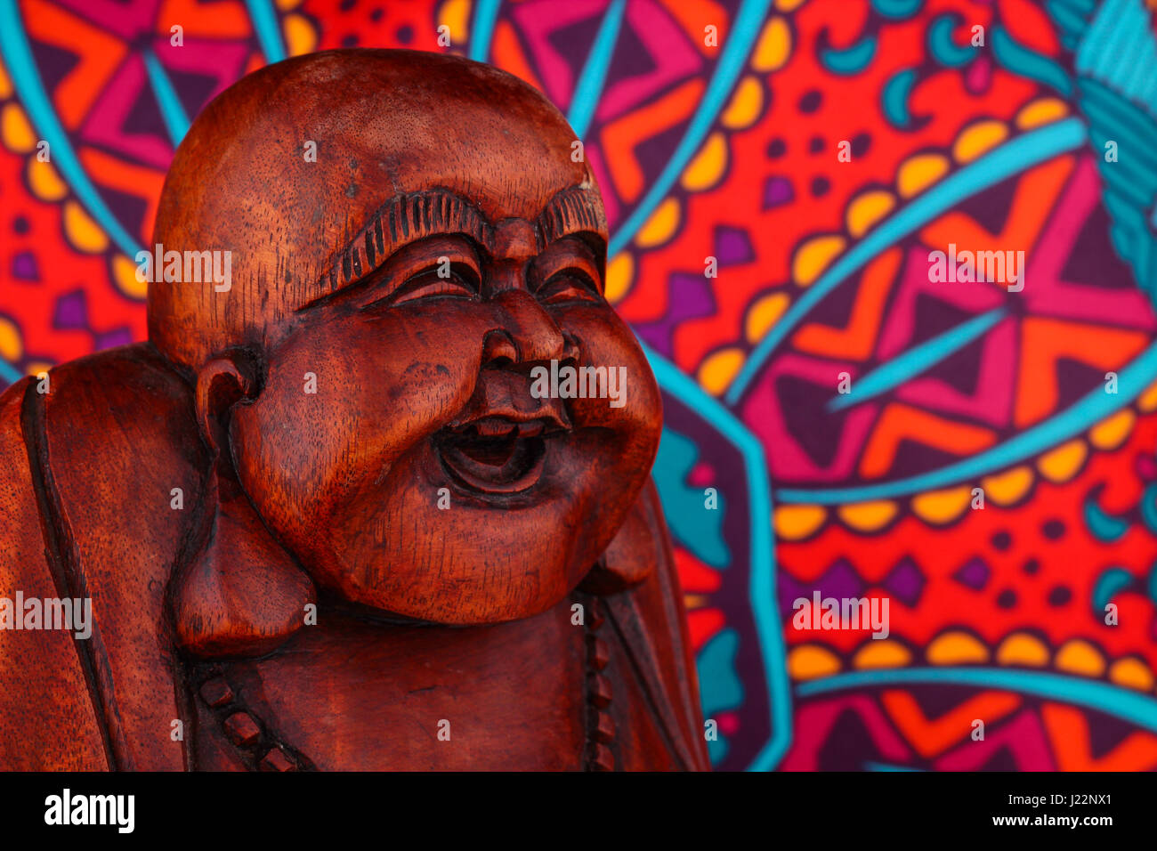 Buddha statue on a colorful background / featuring a wooden statue of ...
