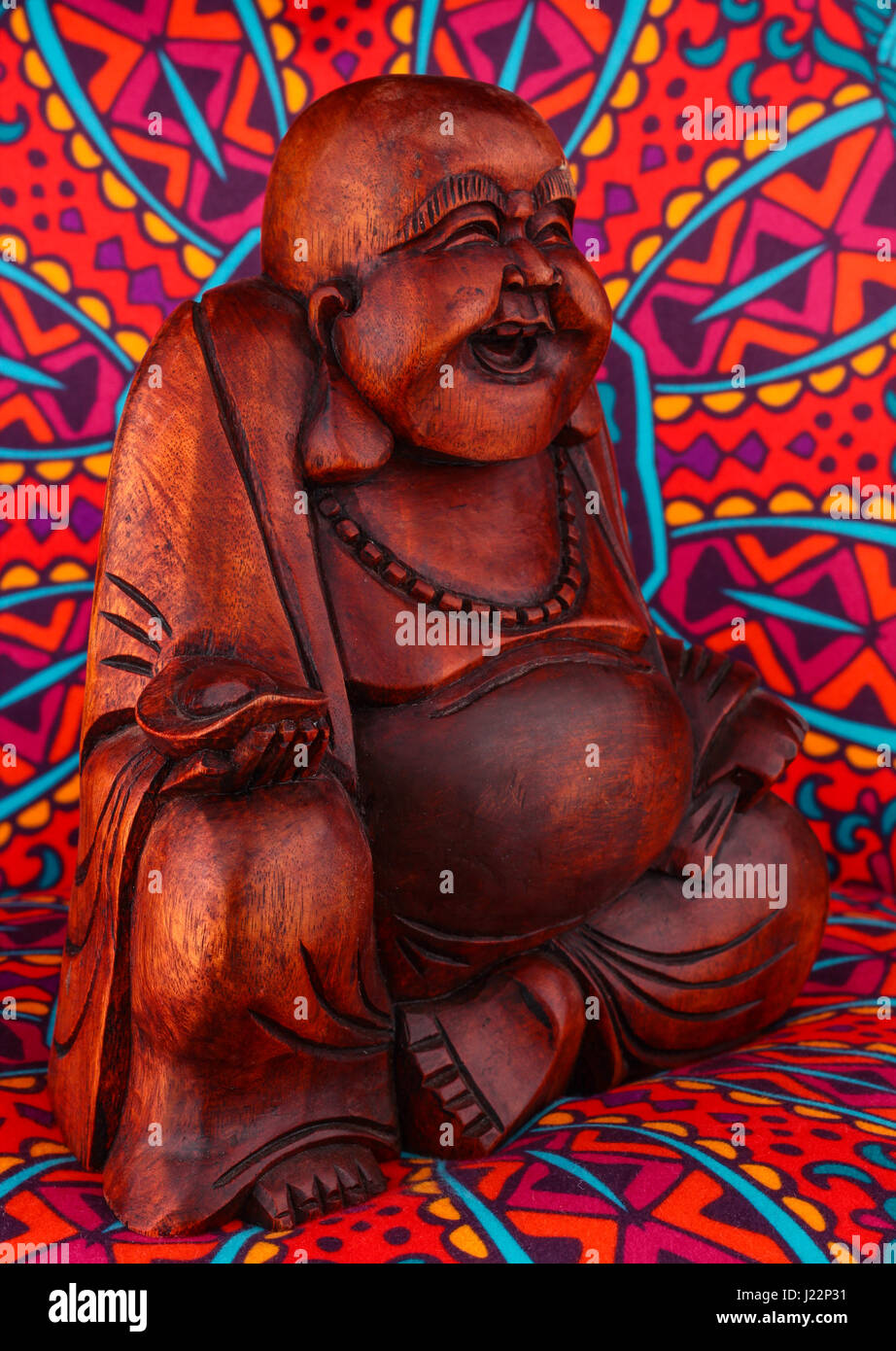 Buddha statue on a colorful background / featuring a wooden statue of ...