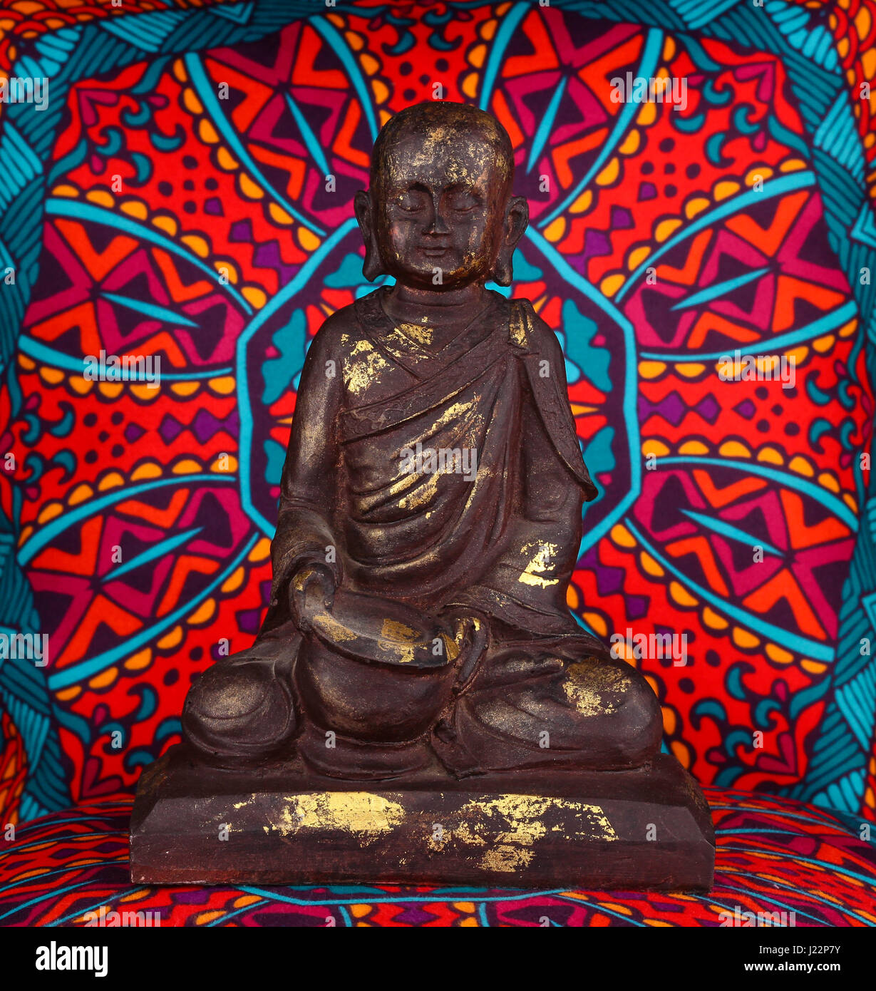 Buddha statue on a colorful background / featuring a wooden statue of ...