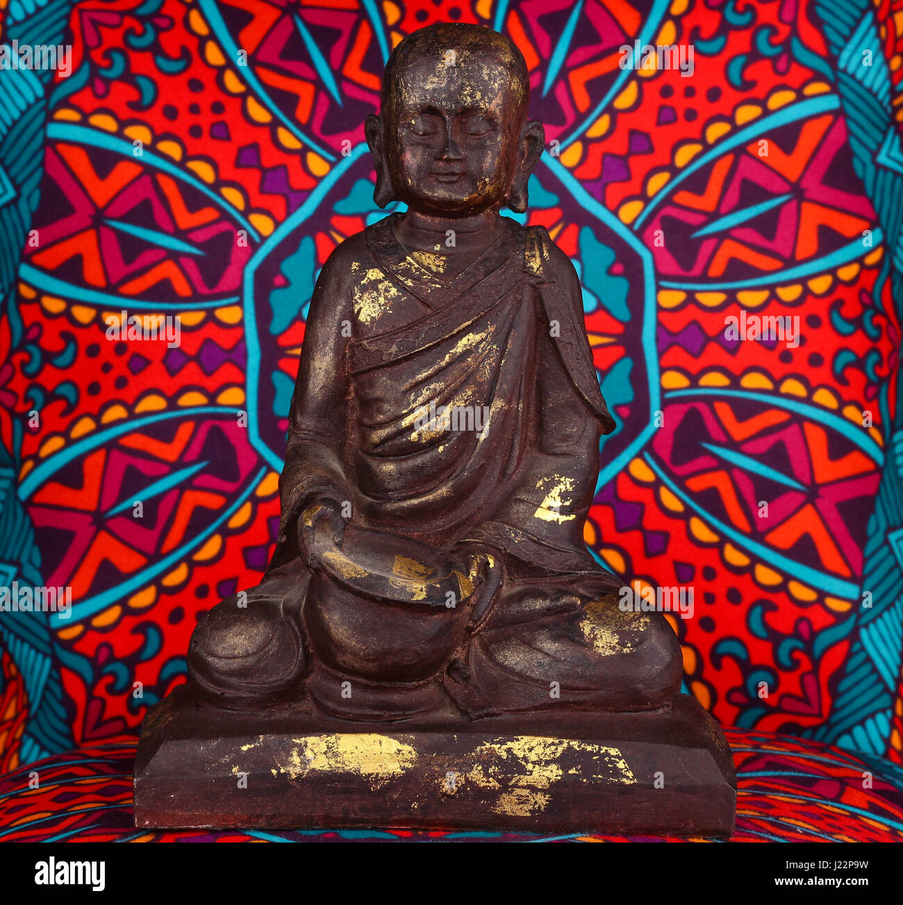 Buddha statue on a colorful background / featuring a wooden statue of ...