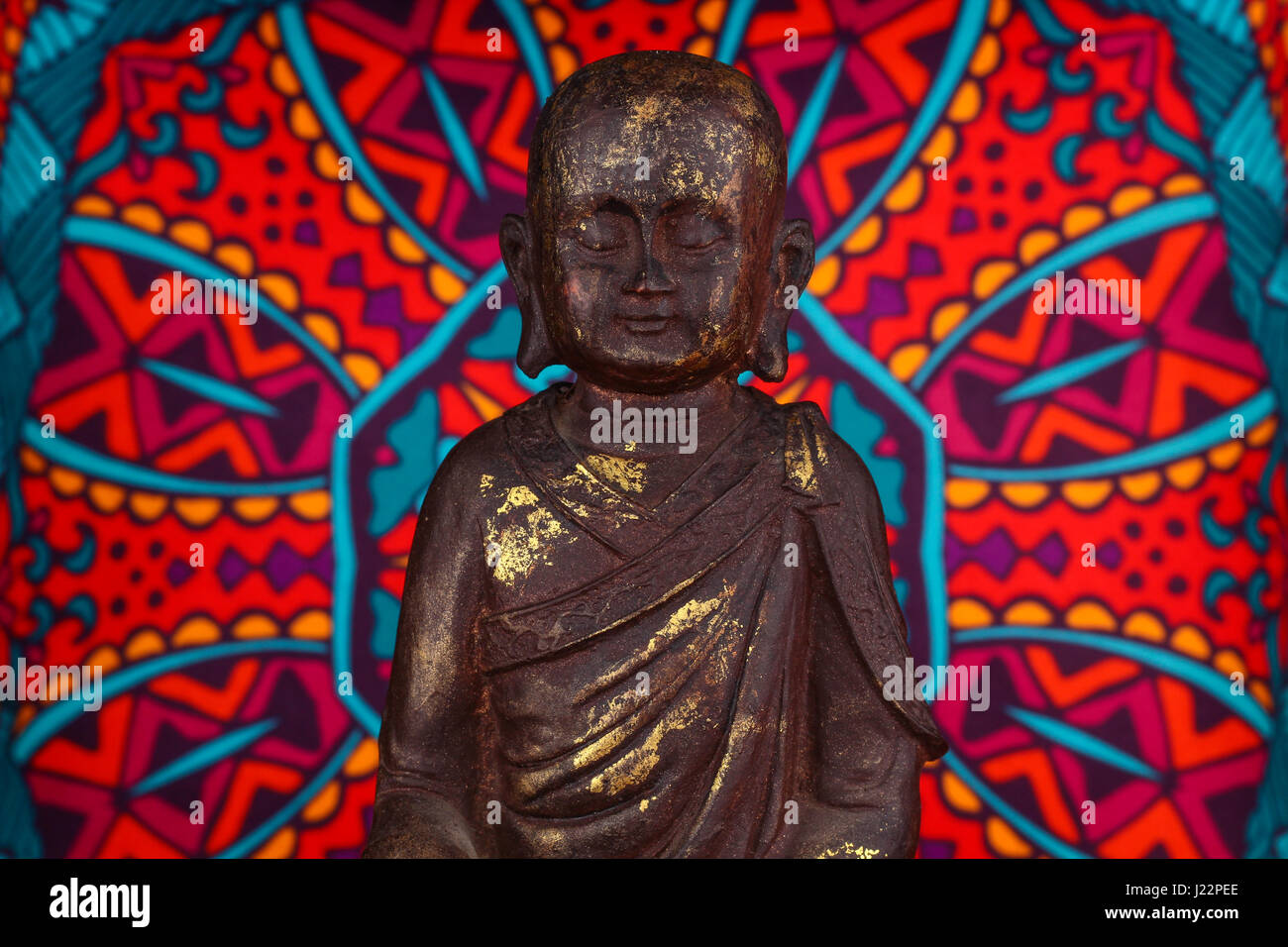 Buddha statue on a colorful background / featuring a wooden statue of ...