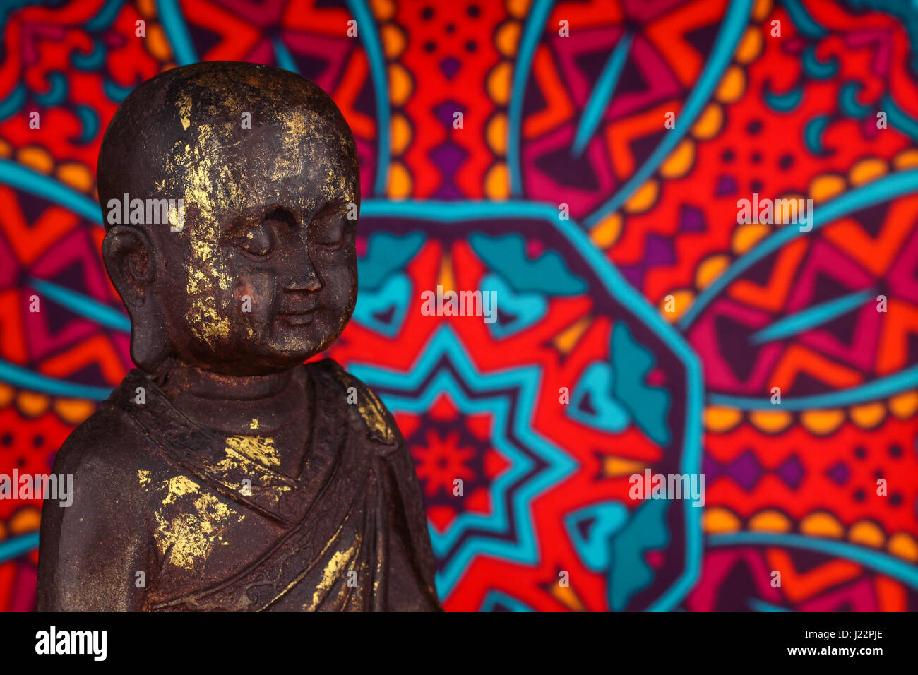 Buddha statue on a colorful background / featuring a wooden statue of ...