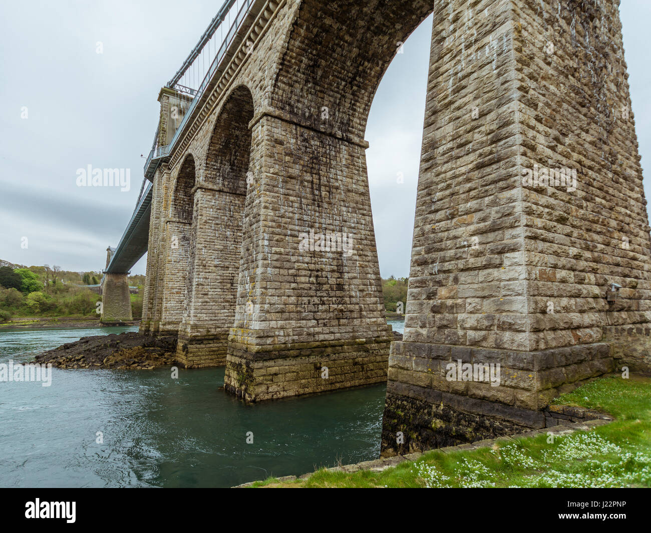 Looking up under the arches of the Menai Bridge from Anglesey Stock ...
