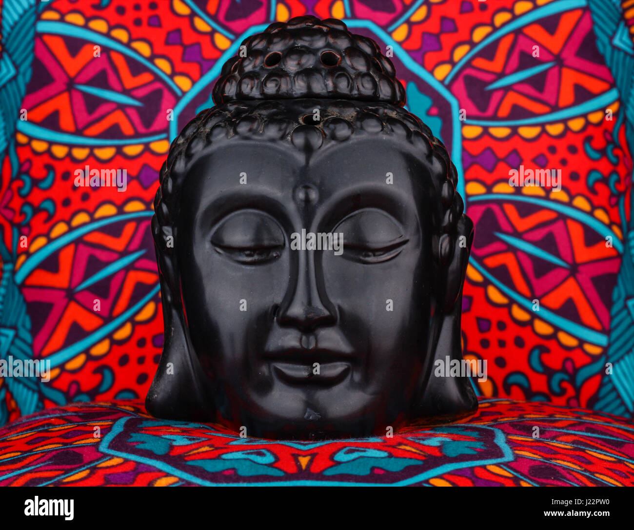 Buddha statue on a colorful background / featuring a wooden statue of ...