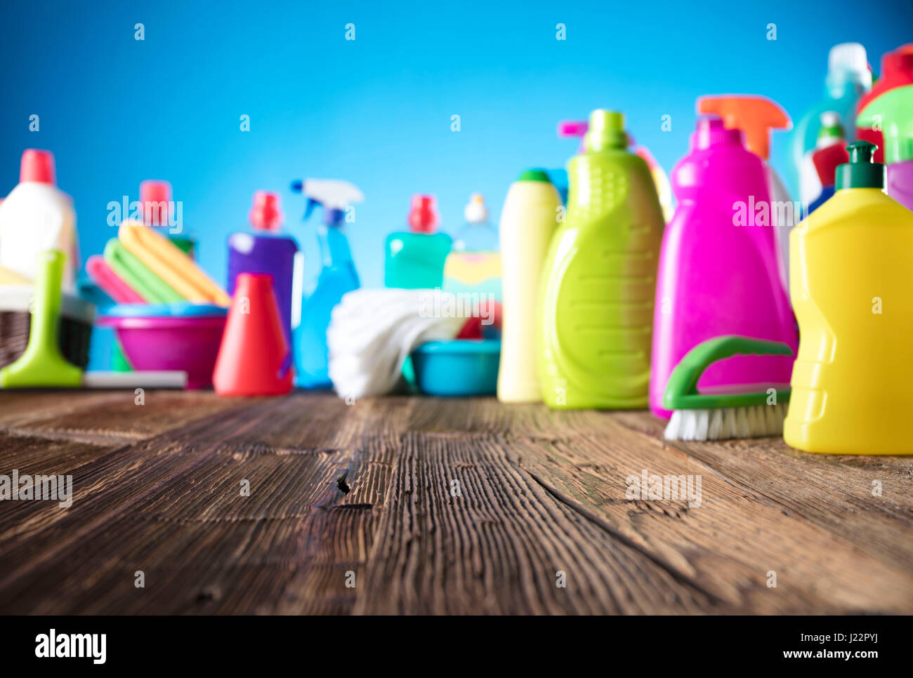 Spring cleanup theme. Variety of colorful house cleaning products on a ...
