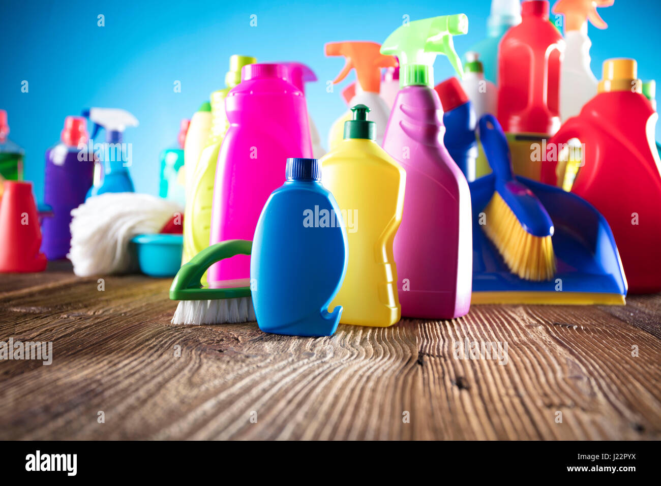 Spring cleanup theme. Variety of colorful house cleaning products on a ...