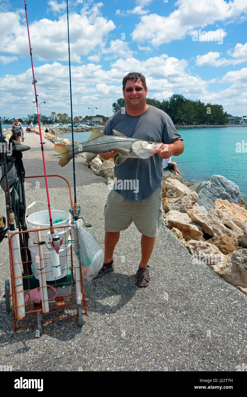 A fisherman in Florida holding a large snook fish Stock Photo - Alamy