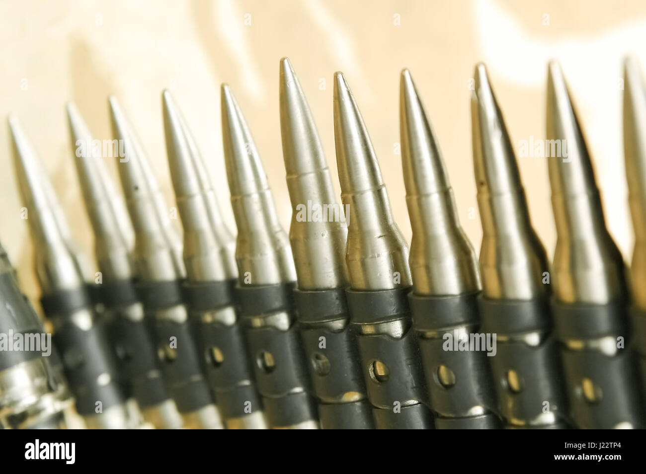 closeup of rifle bullets in an ammunition belt Stock Photo - Alamy