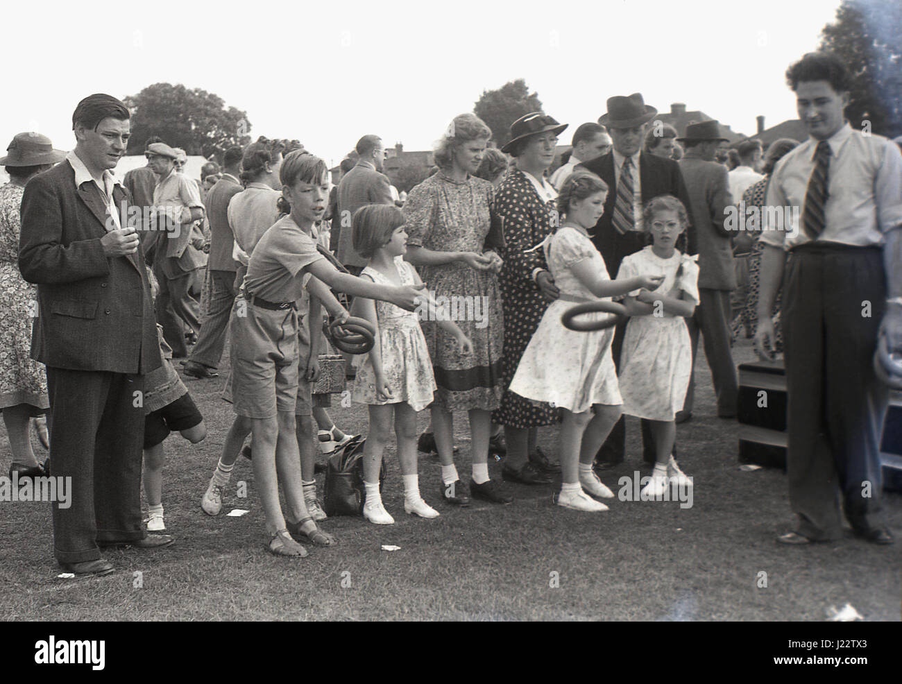 1950s, historical, children playing a game of hoopla - throwing wooden ...