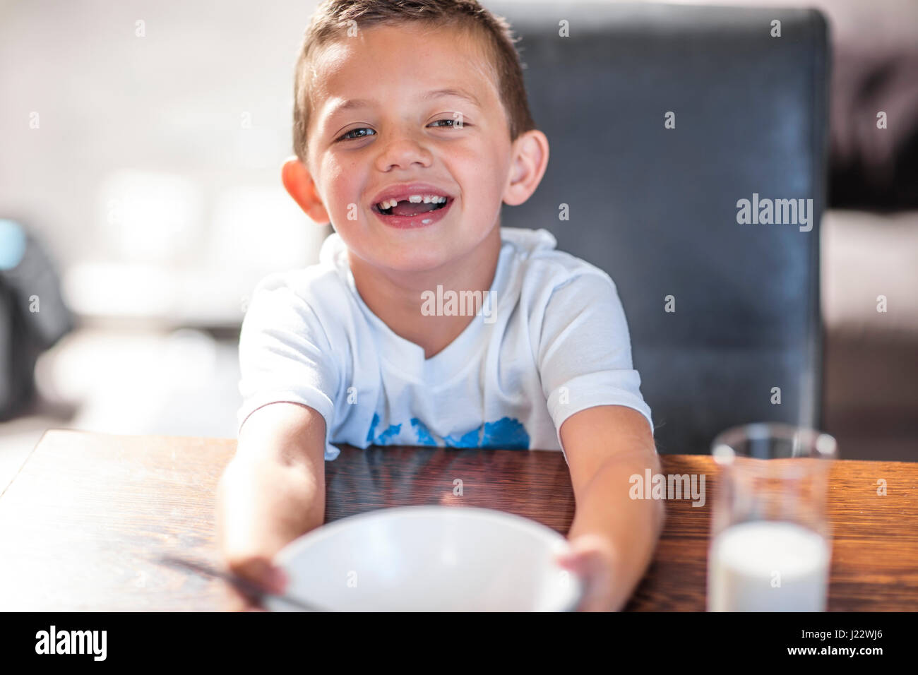 Portrait of smiling boy at dining table Stock Photo - Alamy