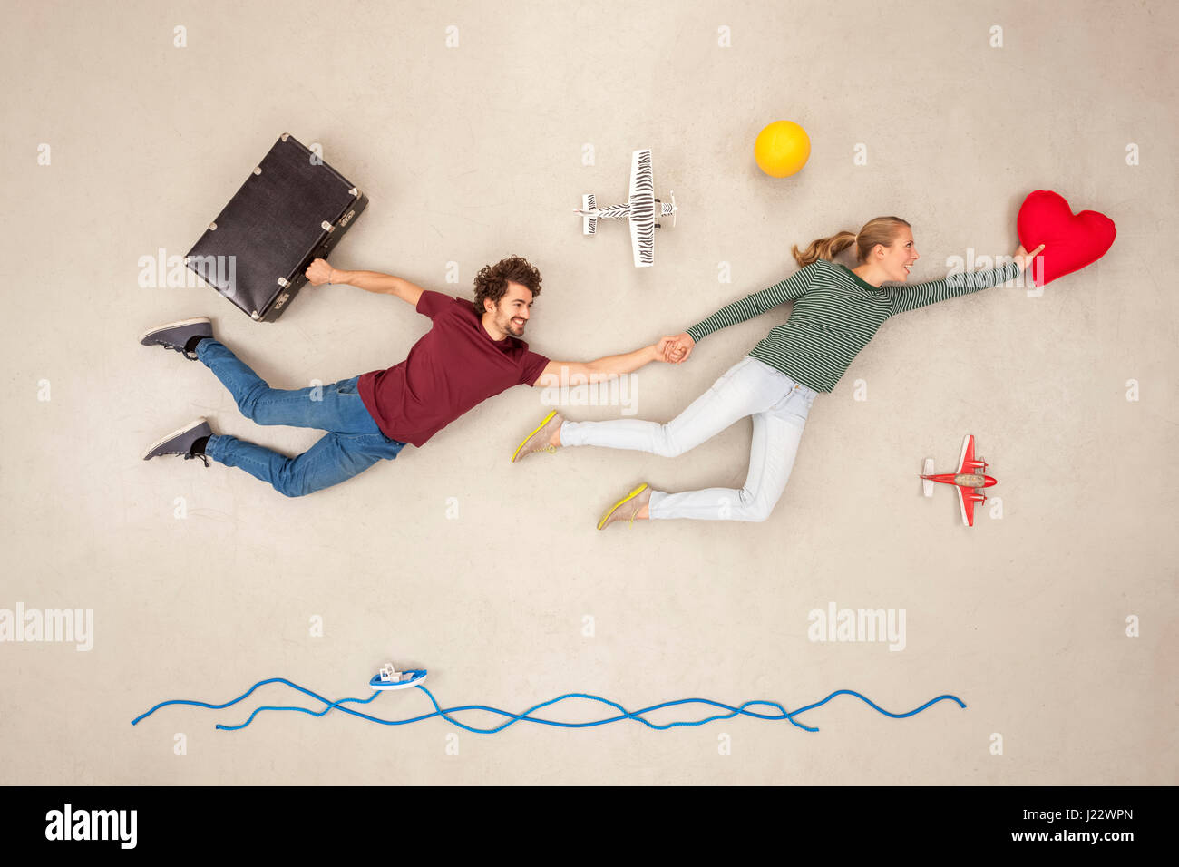 Happy couple flying together for holidays Stock Photo - Alamy