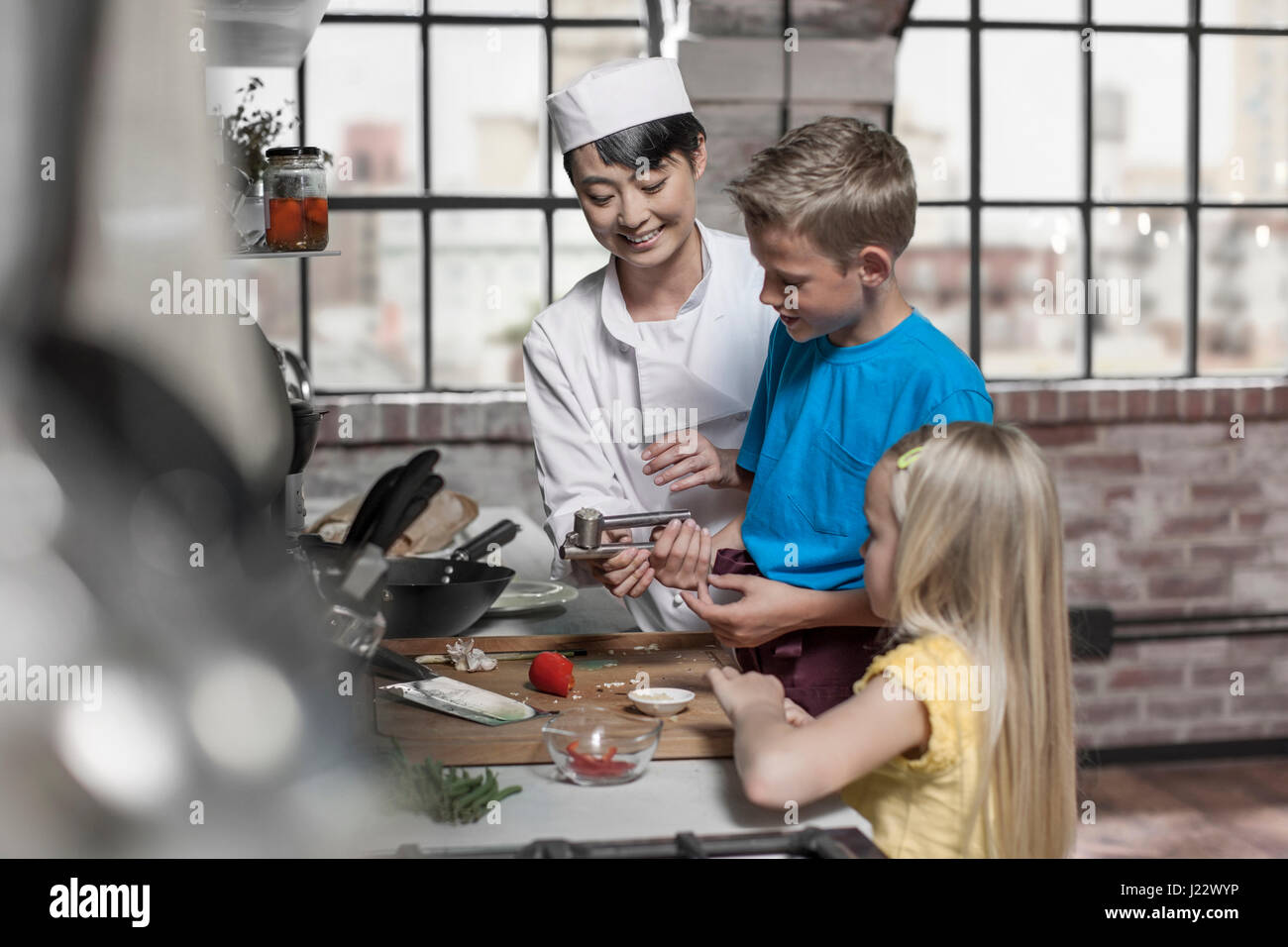 Female chef instructing kids in cooking class Stock Photo - Alamy