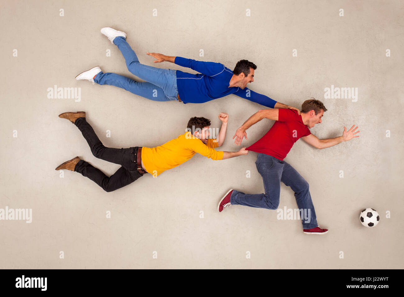 Friends playing soccer together Stock Photo - Alamy