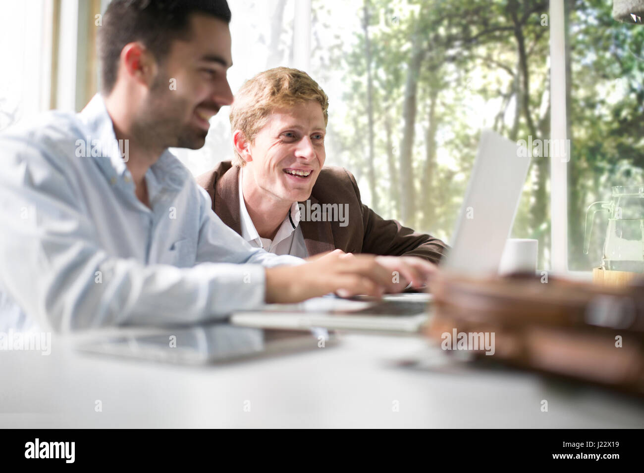 Business people working together, using laptop Stock Photo - Alamy
