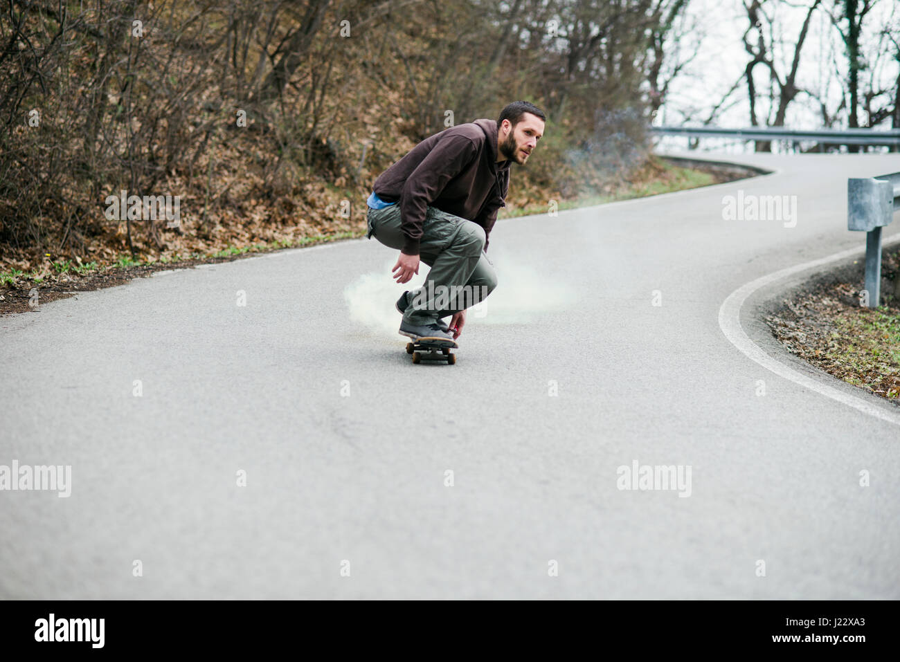 Man skating down the road Stock Photo - Alamy