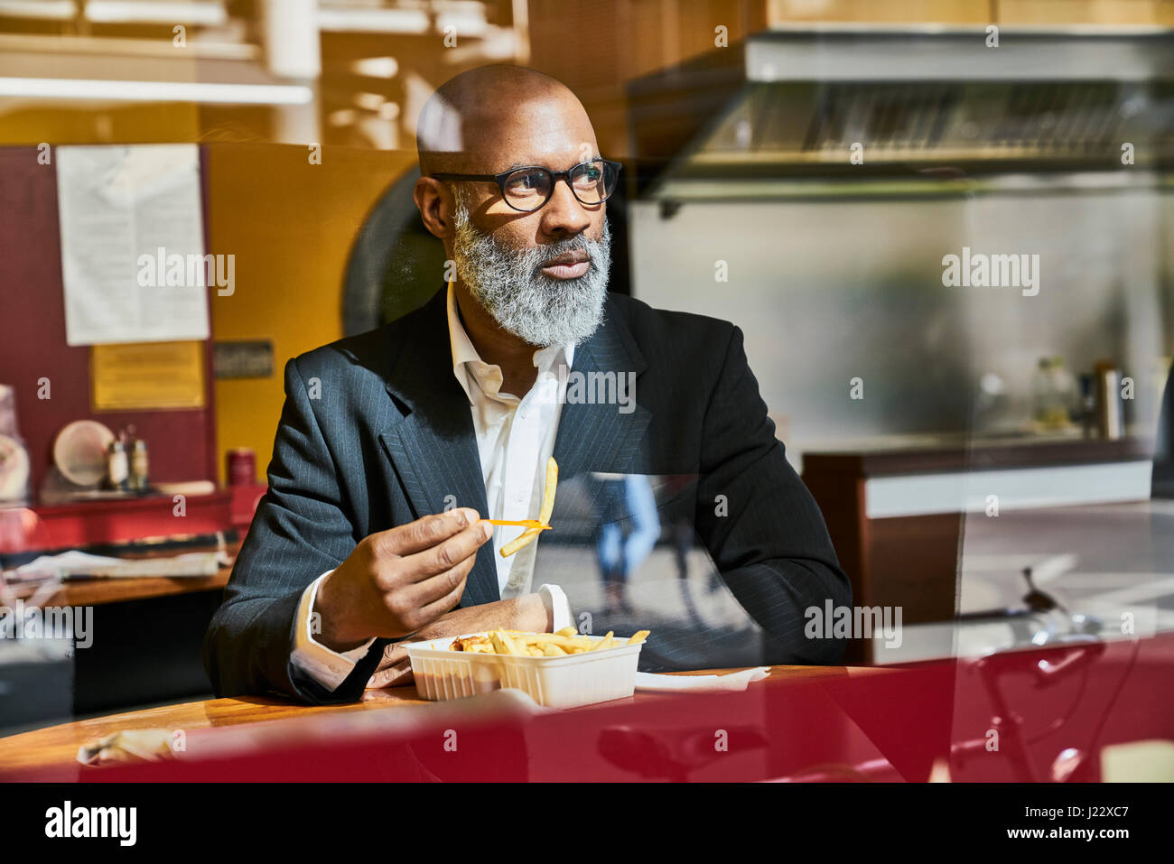 Person of color eating snack bar hi-res stock photography and images ...