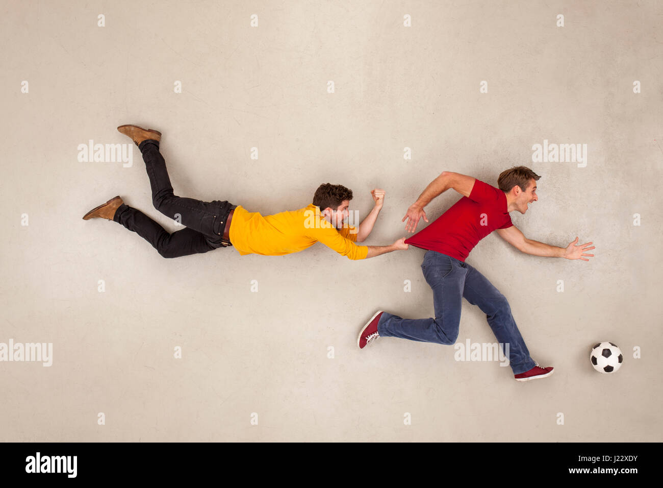 Man playing soccer friends indoor hi-res stock photography and images ...
