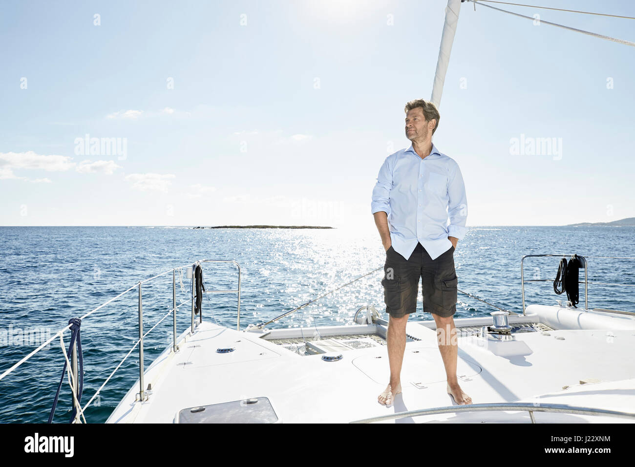 Mature man standing on sailing boat Stock Photo - Alamy
