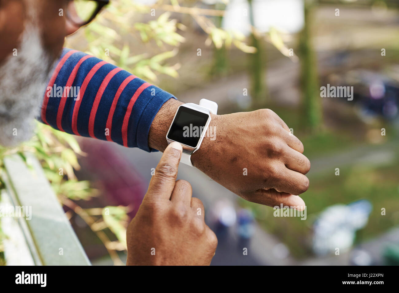 man looking at smartwatch Stock Photo - Alamy
