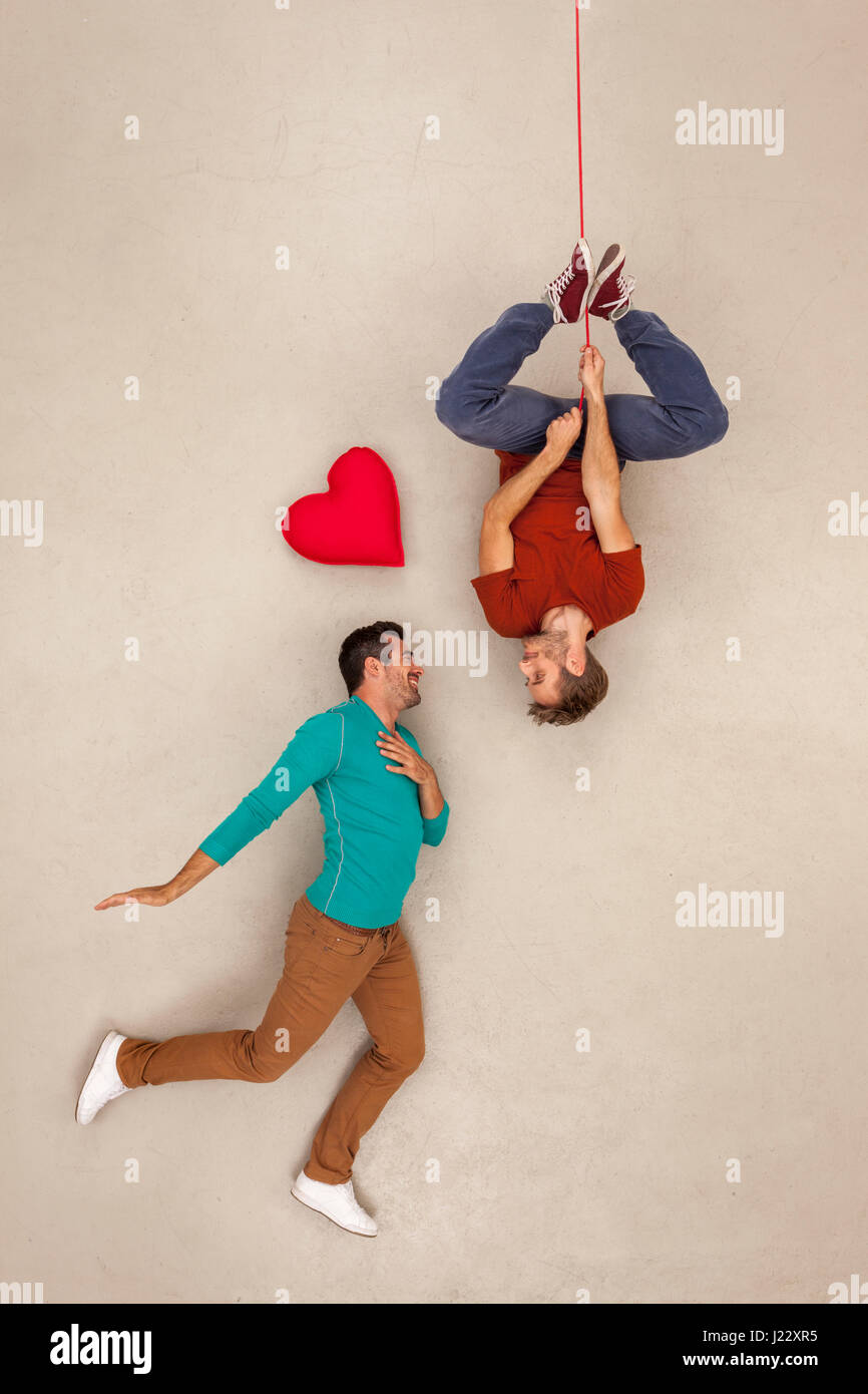 Gay couple falling in love, hanging upside down Stock Photo - Alamy