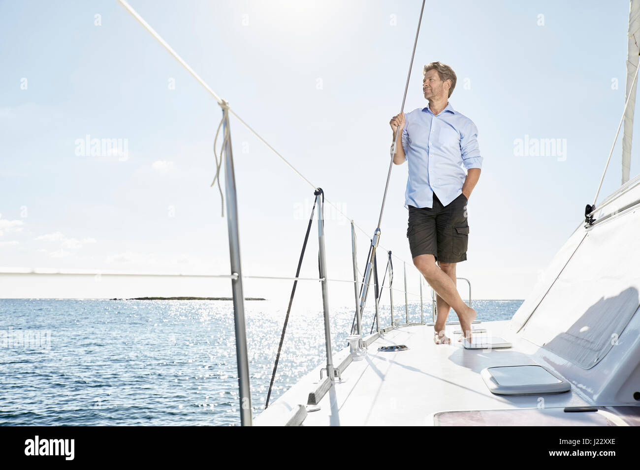 Mature man standing on sailing boat Stock Photo - Alamy