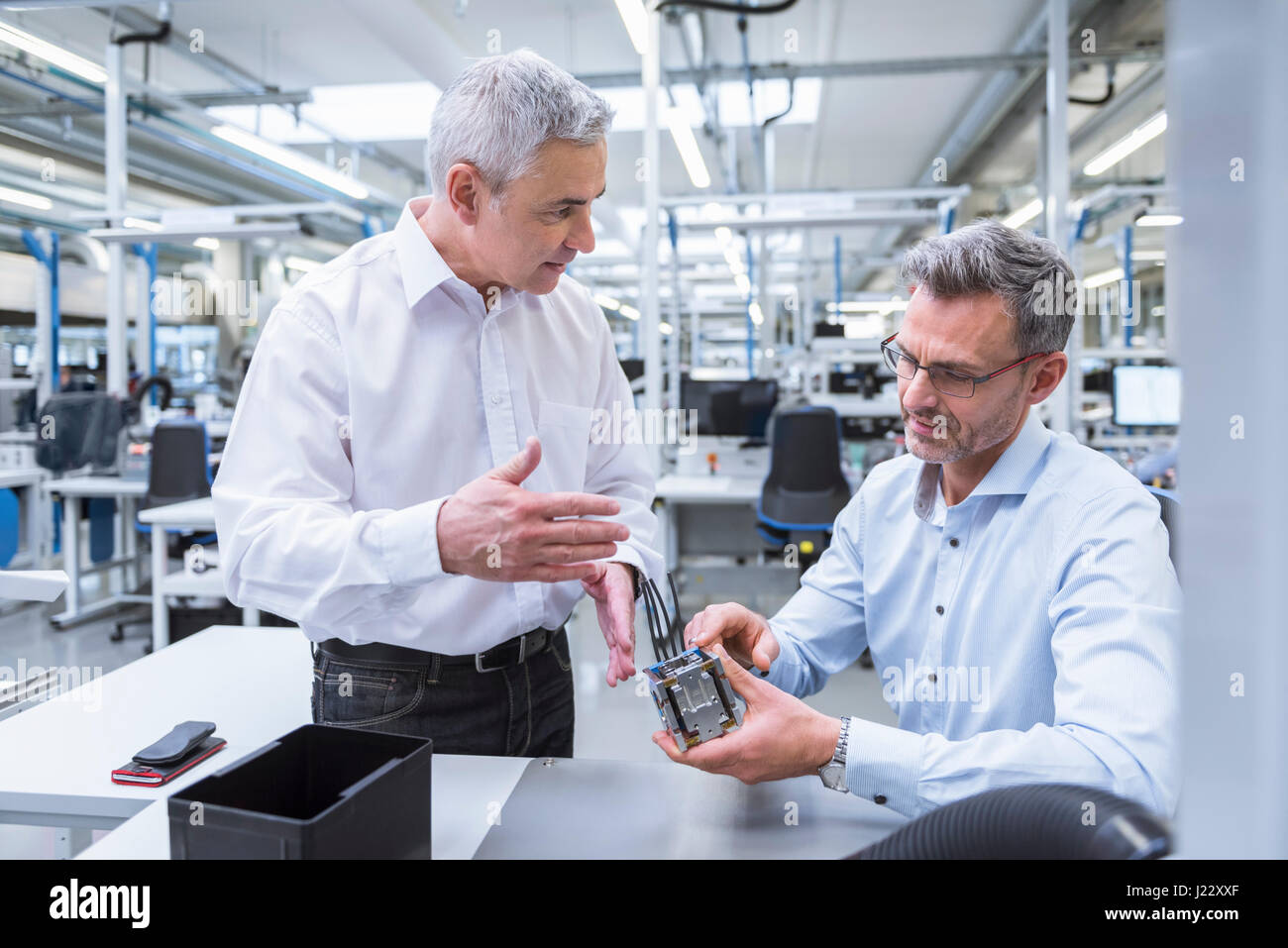 Two managers discussing product in company Stock Photo - Alamy