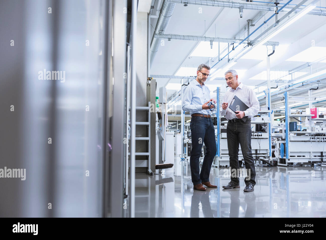 Two managers in company, discussing new product Stock Photo - Alamy
