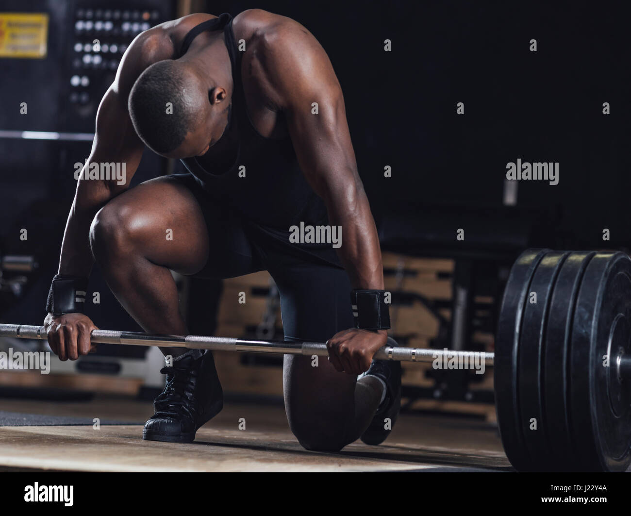 Athlete in gym doing weight lifting Stock Photo - Alamy