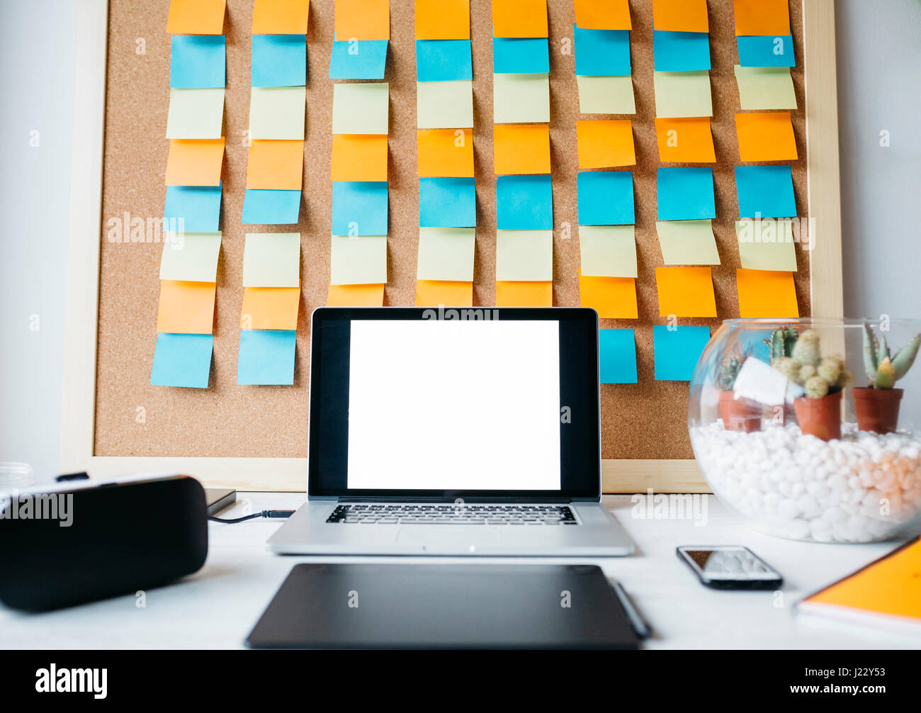 Desktop with laptop, virtual reality glasses, graphics tablet, cell ...