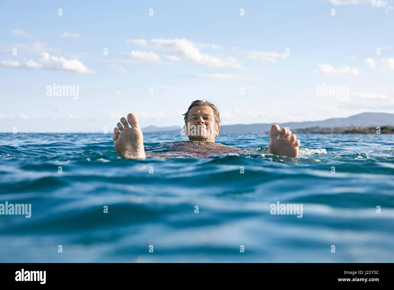 Relaxed mature man floating in the sea Stock Photo - Alamy