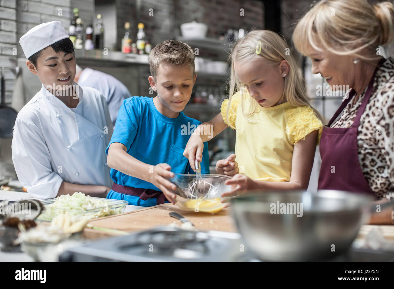 Kids cooking in cooking class Stock Photo - Alamy