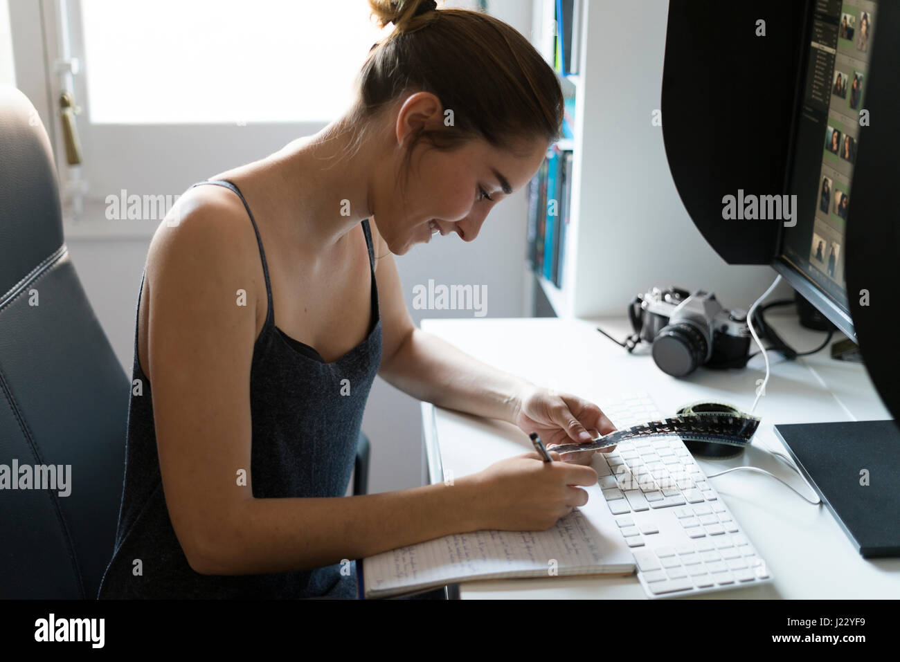 Female photographer editing images at desk Stock Photo - Alamy