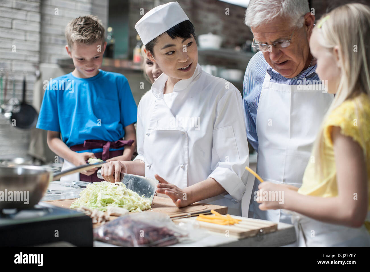 Female chef instructing kids in cooking class Stock Photo - Alamy