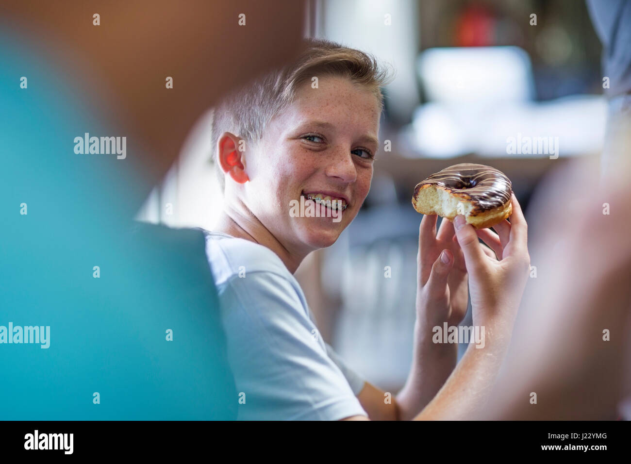 Boy enjoying his doughnut Stock Photo - Alamy